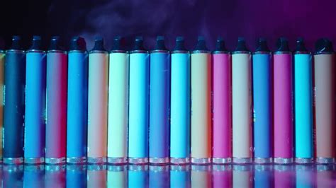 Lots Of E Cigarettes And Vapes With Smoke In Neon Lighting Concept Bad