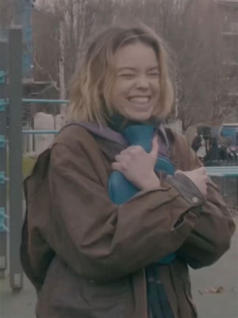 A Woman Standing In Front Of A Playground With Her Arms Crossed And