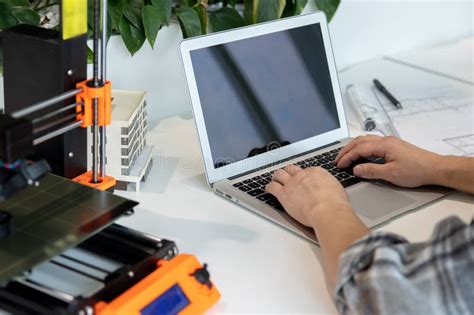 Man Typing On Laptop With Blank Screen Working In Creative Lab Stock