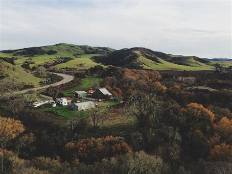 Farm Under Green Hills By Stocksy Contributor Kevin Russ Stocksy