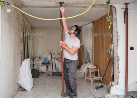 Construction Worker Placing The First Pillar Prop Or Strut To Prevent A Collapse Stock Photo By