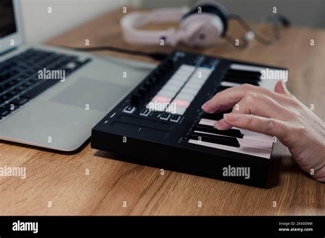 midi keyboard musician playing midi keyboard for arranging music on