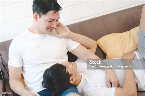 Happy Asian Gay Couple Hug Together On Sofa Asian Lgbt Couple Embracing