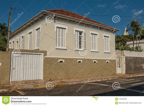 Working Class Old House With Garage Door And Palm Tree In An Empty