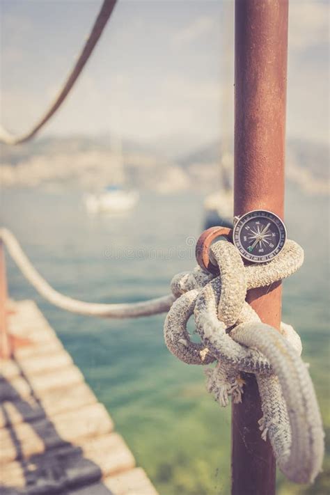 Sailing Nautical Compass On A Sailing Rope Pier Sailing Boats In The Background Stock Image
