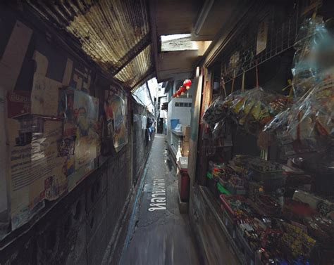 People Live In The Tiny Gap Between Commercial Buildings And The