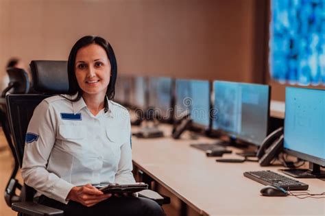 Female Security Operator Working In A Data System Control Room Offices