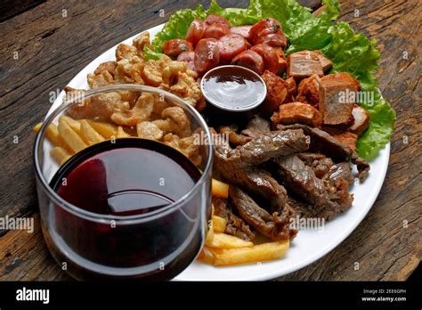 Snacks With Fries Crackers Meat Pork Sausage Babercue Sauce And Glass Of Red Wine Stock