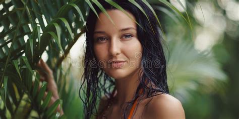 Wet Woman In Orange Swimsuit Among Tropical Leaves Close Up Stock Image Image Of Fashion