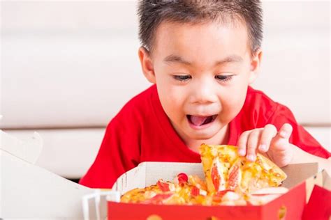 Premium Photo Portrait Of Boy Eating Food