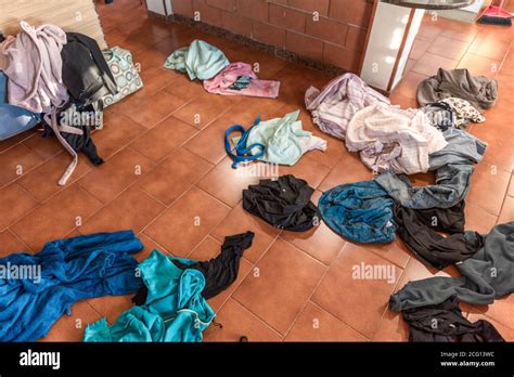 A Woman Has A Lot Of Clothes Which Is Messy Clothes And Placed On The