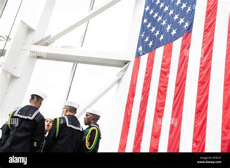 Sailors Sing The National Anthem During A Winging Ceremony At The