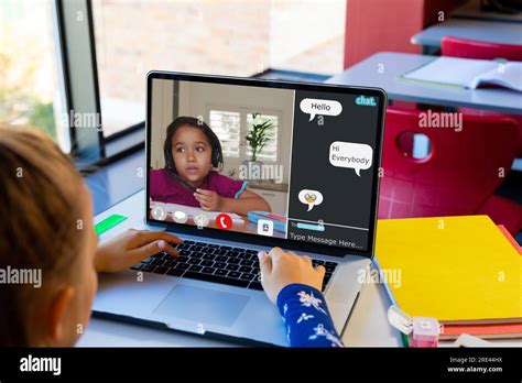 Caucasian Girl Typing On Laptop Keyboard And Looking At Friend During