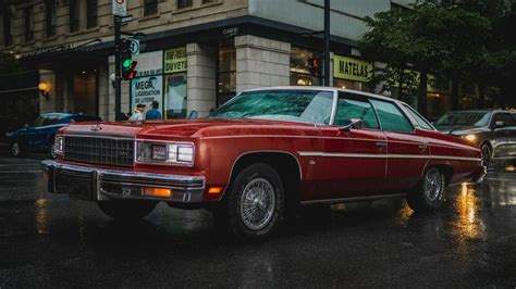 Red Classic Chevrolet Caprice On Wet Urban Streets Backiee