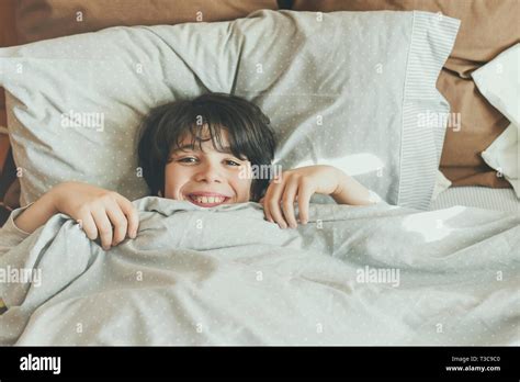 Glücklich Das Kind Auf Dem Bett Nach Dem Aufwachen Stockfotografie Alamy