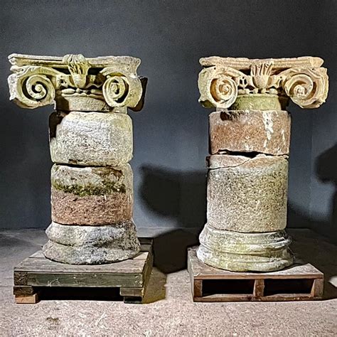 A Pair Of English Carved Limestone Ionic Order Capitals With Associated