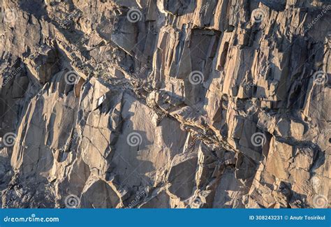 Crumbling Rock Cliff Wall Texture With Cuts And Shadows Of The Granite