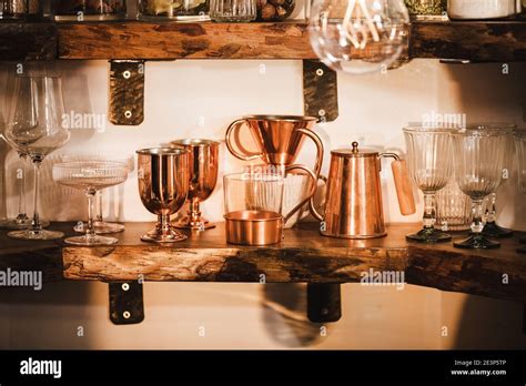 Kitchen Shelves With Various Glass And Copper Glassware Mugs Tumblers