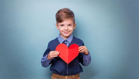 Premium Photo Concept Of Knowledge A Boy With A Red Paper Heart