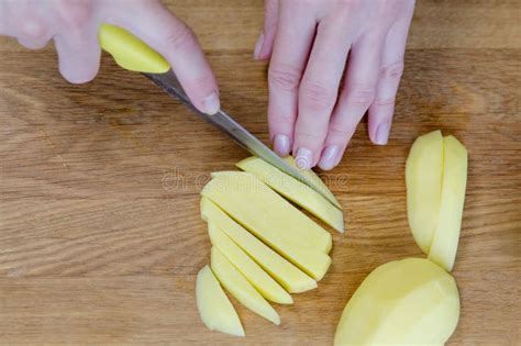 A Hand Cuts Potato Into A Small Sticks Close Up Cooking Fries Top View Stock Image Image Of