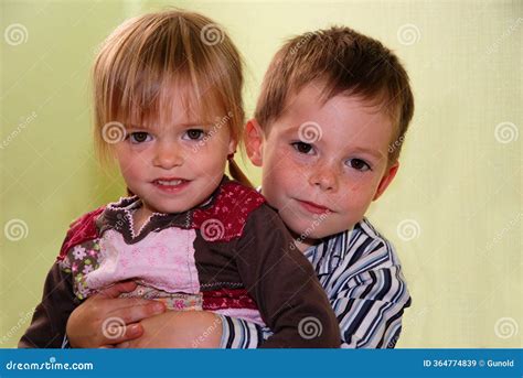 Two Cute Siblings Lying On Bed Fokus Frome Above Stock Image