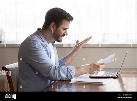 Handsome Guy Annoyed By Paper Dismissal Notice Document Mistake Stock Photo Alamy