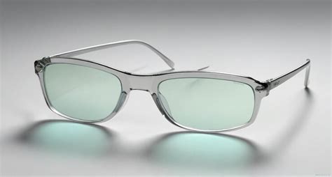 A Pair Of Glasses With A Silver Frame And A Reflection Of The Glasses