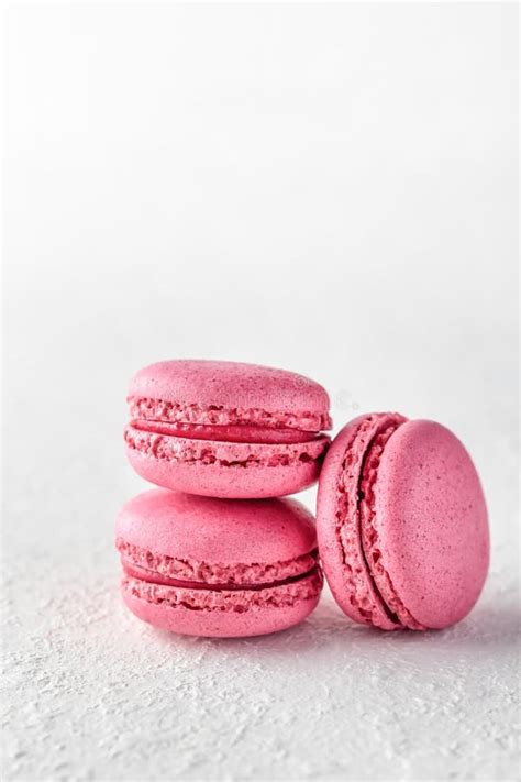 Stack Of Pink Macarons On White Textured Background Isolated Stock