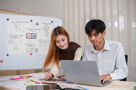 A Team Of Asian Designers Creates And Designs Ux Ui Brainstorming