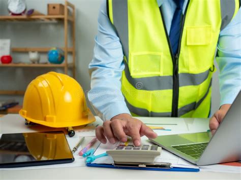 Architect Or Engineer Using Computer To Work On Desk Cost Calculation