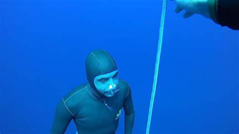 Diving Deep Underwater Barefaced In Wetsuit