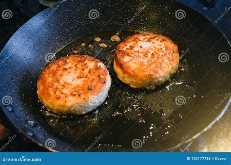 Two Round Cutlets From Meat Of Beef Are Fried In A Frying Pan And Oil