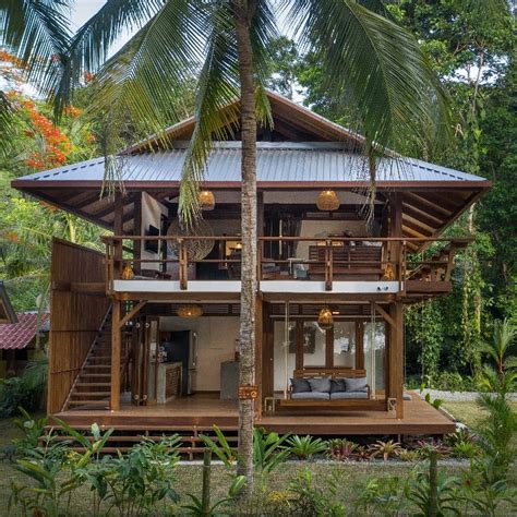 House In The Middle Of Trees House On Stilts Tropical Tropical House