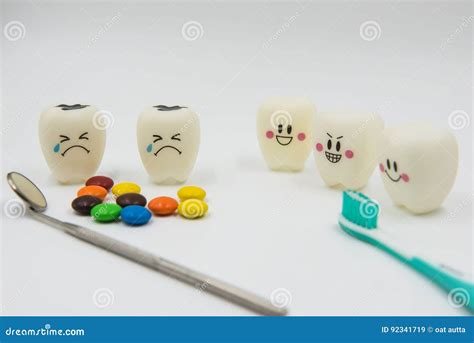 Model Cute Toys Teeth And Colorful Candy In Dentistry On A White