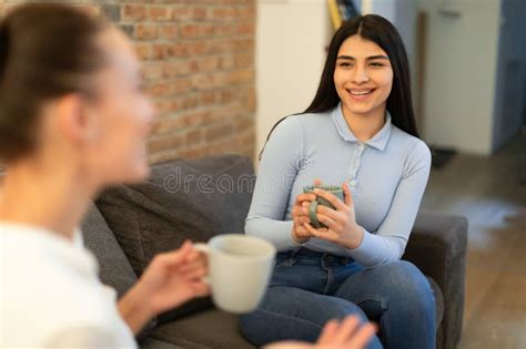 Happy Teen Ladies Fellows Meeting Drinking Coffe Chatting Sharing News And Rumours Sitting
