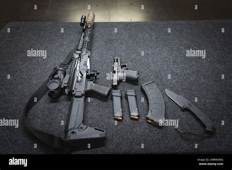 Weapons In A Shooting Range An Akm Rifle With A Silencer And A Weapon Flashlight A G19 Pistol