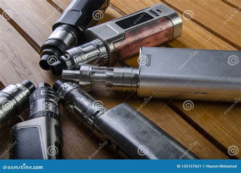 Electronic Cigarette Mods For Ecig Over A Wooden Background Vape