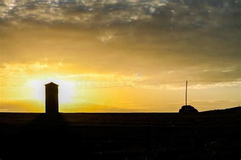 Sunset Behind The Building Of An Old Electricity Transformer Stock