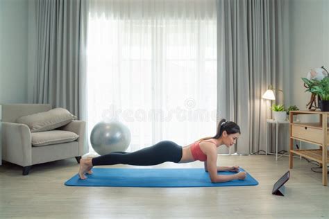 Asian Woman Exercise And Stretching In Her Bed Room Her Try To Make