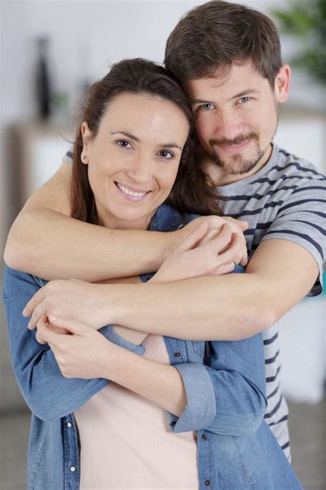 Happy Couple Hugging And Working Together At Home Stock Image Image