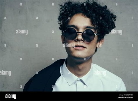 Handsome Guy Model In Shirt And Glasses Jacket On Shoulder Portrait
