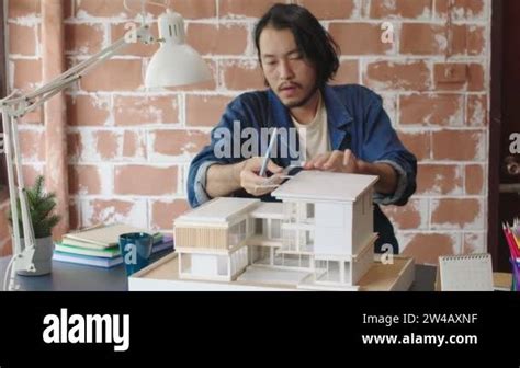 Smart Asian Male Architect Working With His Architectural Model