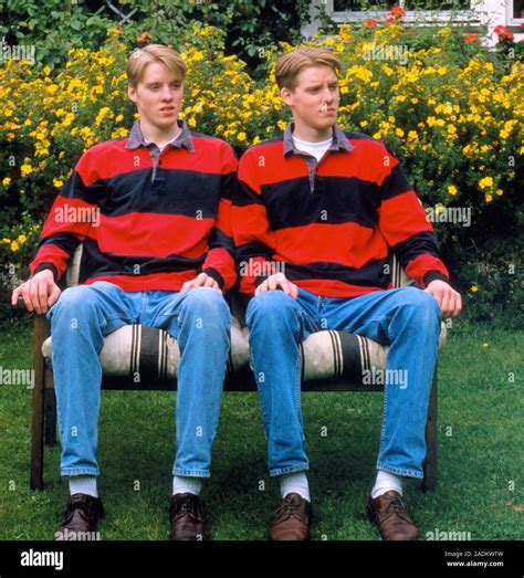 Adult Dizygotic Twins These Healthy Twenty One Year Old Male Twins Are Sitting On A Garden