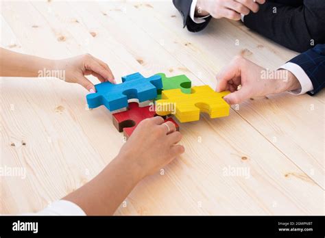 Business People Team Assembling Four Color Jigsaw Puzzle Pieces Unity Cooperation Ideas Concept