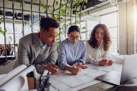 Collaborative Workspace Featuring A Team Engaging In Comprehensive