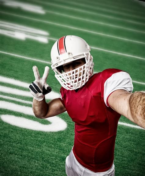 Premium Photo Football Player With A Red Uniform Making A Selfie On A