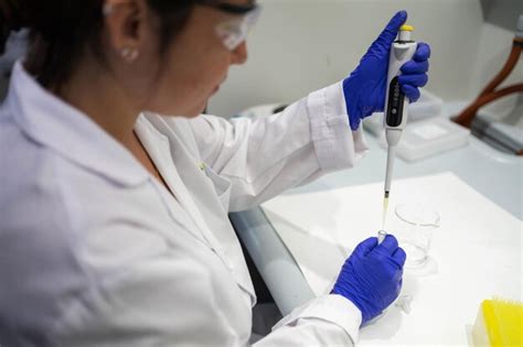 Premium Photo A Scientist Extracting A Liquid Sample