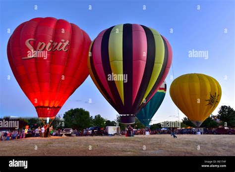 Hot Air Balloons In Early Evening With Canopies Filled With Hot Air And Burner Alight Prescott
