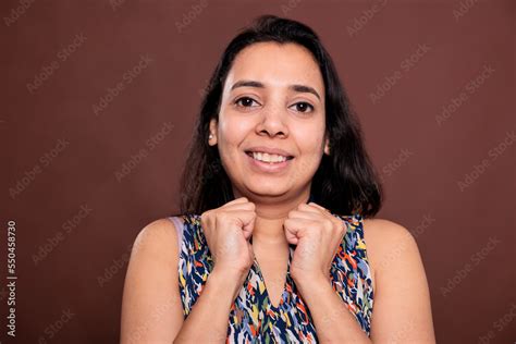 Smiling Indian Woman With Clenched Fists Near Cheeks Medium Close Up Portrait Cute Pose