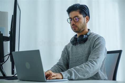 Asian Man Prompt Engineer Develop Coding App With Software Data Sitting In Front Of Computer